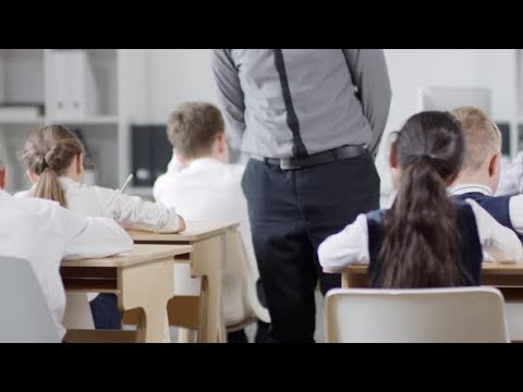 Pupils Drawing and Male Teacher Walking Around Classroom | Stock Footage - Videohive