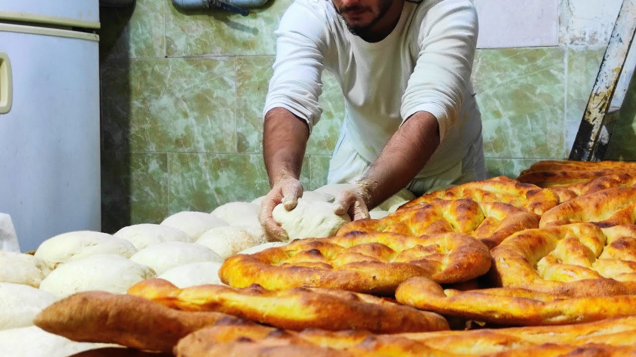 traditional barbari bread . Baking bread in the shop and on the street ...
