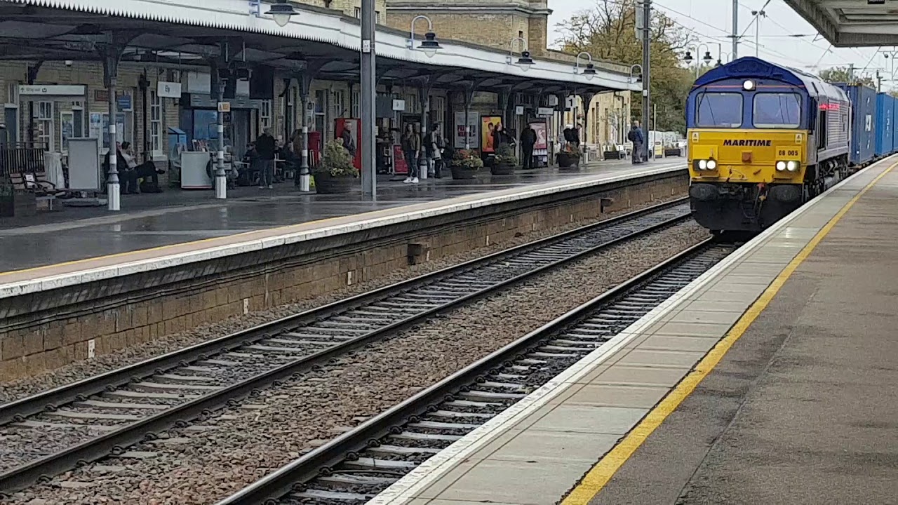 Class 66 66005 in maritime colours passing through Ely - YouTube