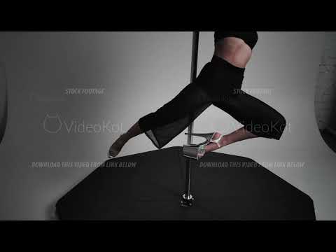 Slow motion of seductive female pole dancer on high heels training in studio