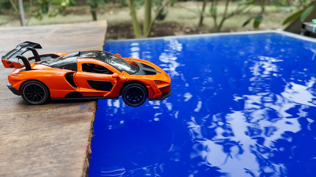 blue water stream and amazing diecast cars falling into the blue ...