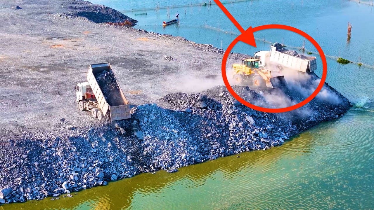 Amazing movement of strong dozers and dump trucks dumping rock into ...