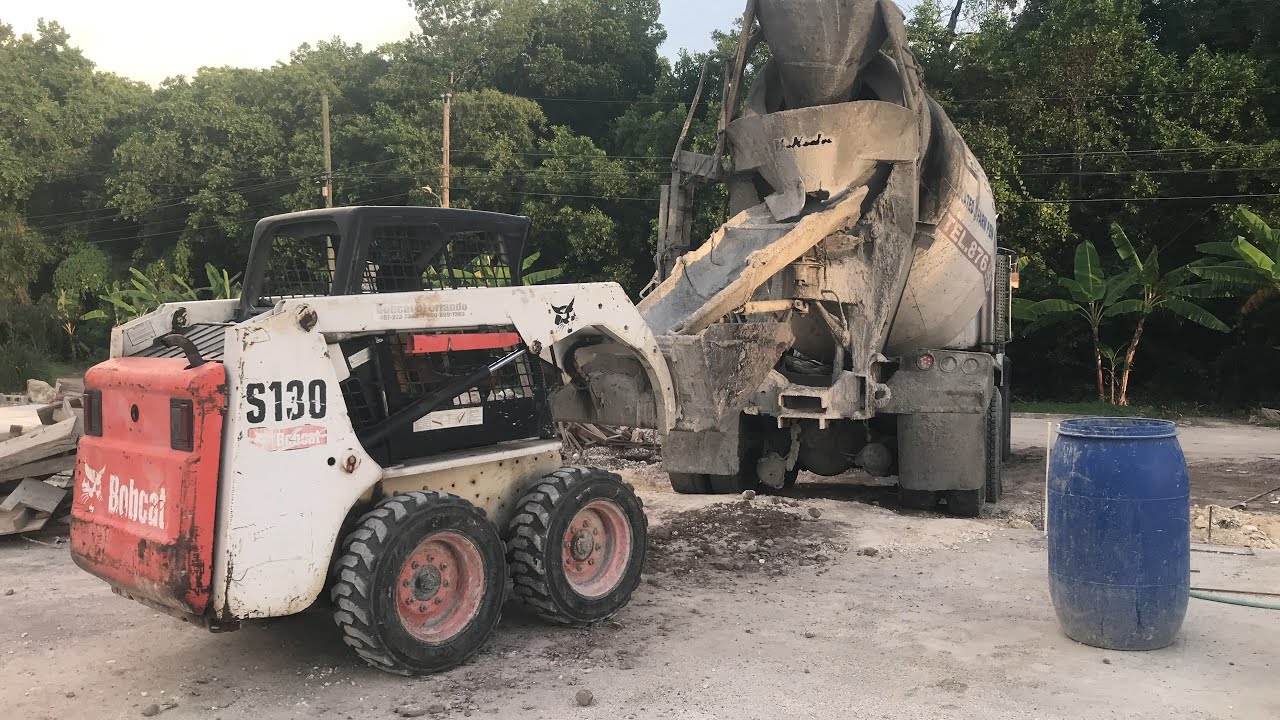 Bobcat offloading cement l Construction - YouTube