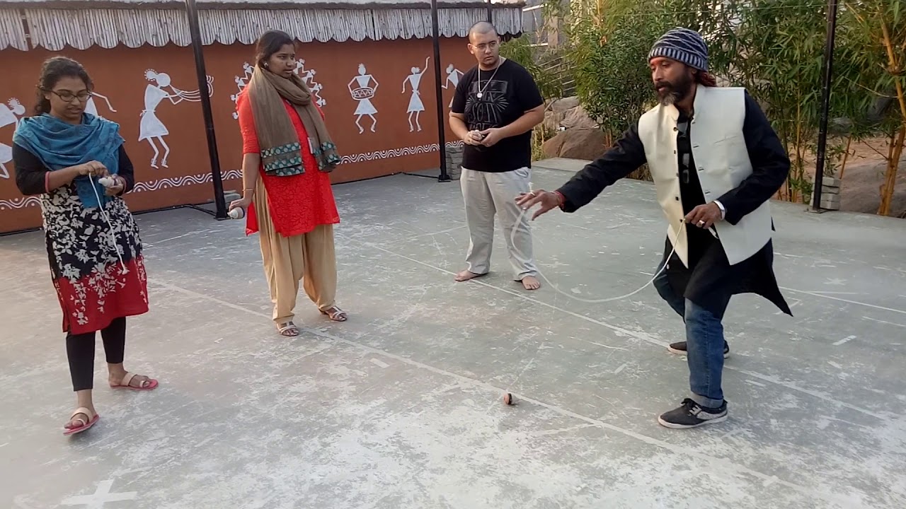 Adla Satish Kumar explaining the lattu bongaram top game to ...