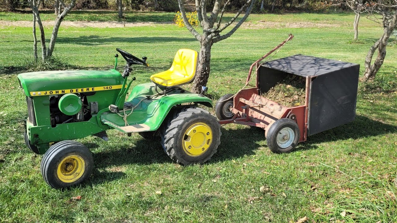 cleaning up tall thick grass with John Deere 140 acreage estate rake ...