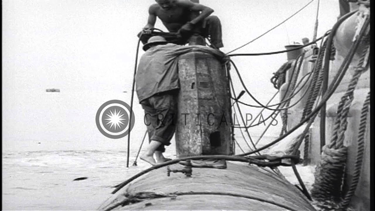 A Japanese submarine comes up alongside USS Ortolan in the Pacific ...