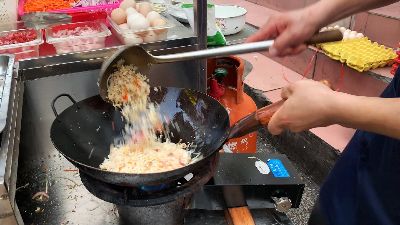 Fried rice with sausage and eggs on the street, the rice fried in a ...