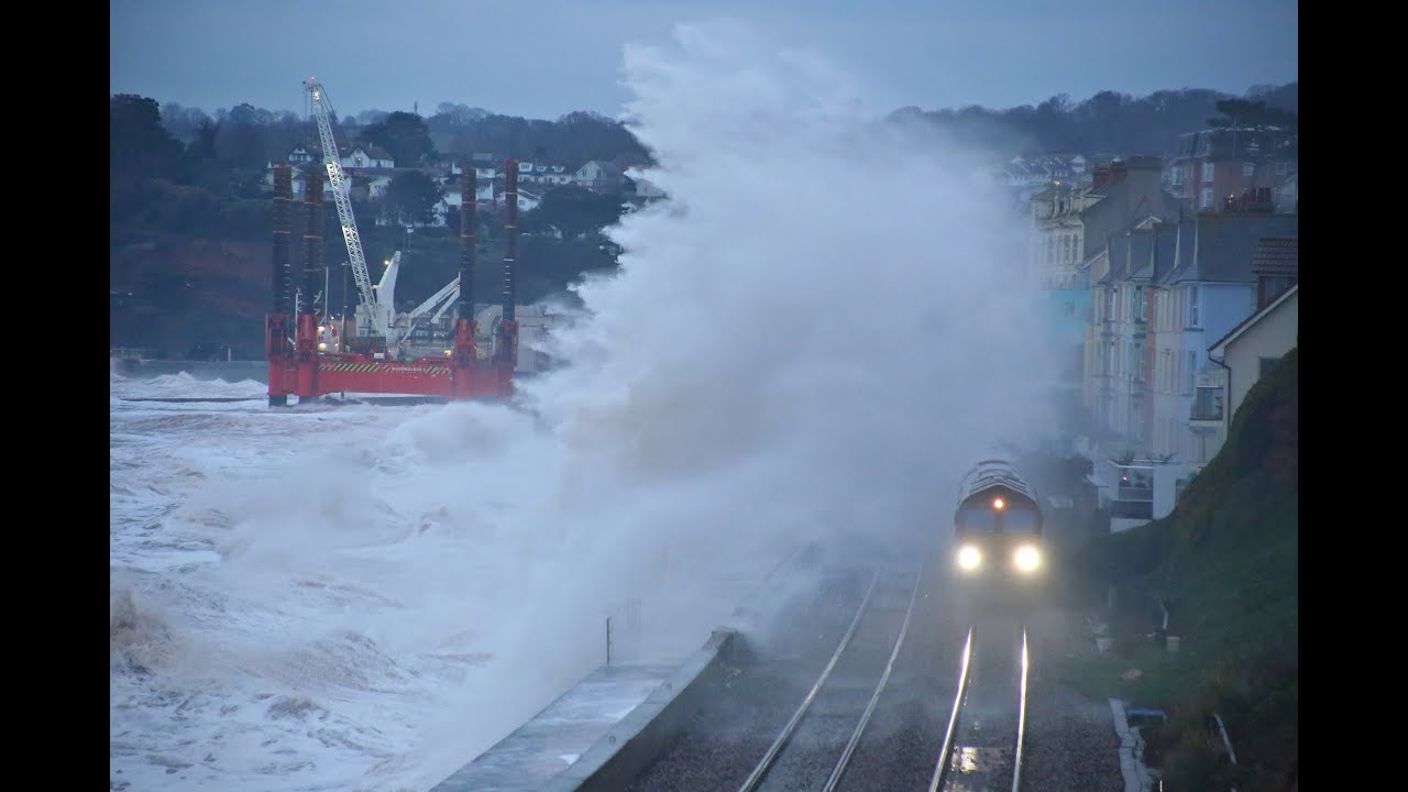 Severe Weather with Waves crashing over trains on the Dawlish Sea Wall ...