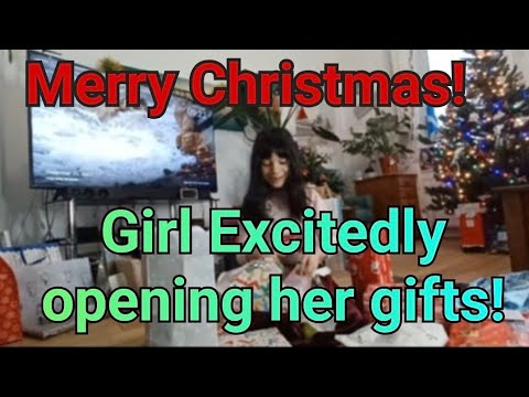 Girl excitedly opening her Christmas Gifts of 2025