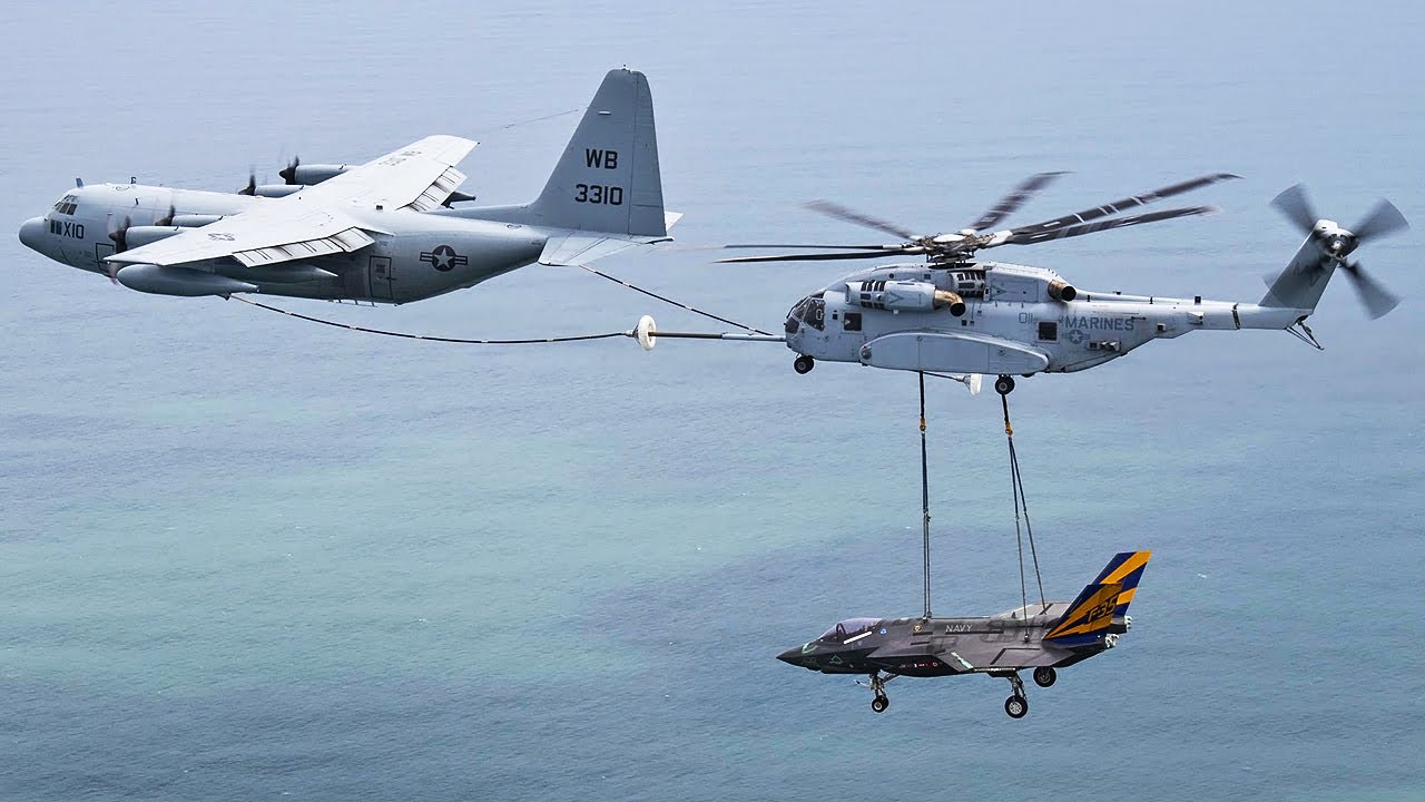 A CH-53K, US biggest helicopter, lifts a F-35 stealth fighter while refueling from a KC-130 ...