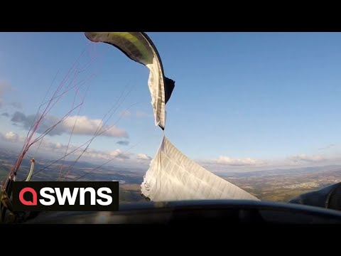 Paraglider nearly plunges 2,500 feet after the wing on his paramotor malfunctions mid-flight | SWNS