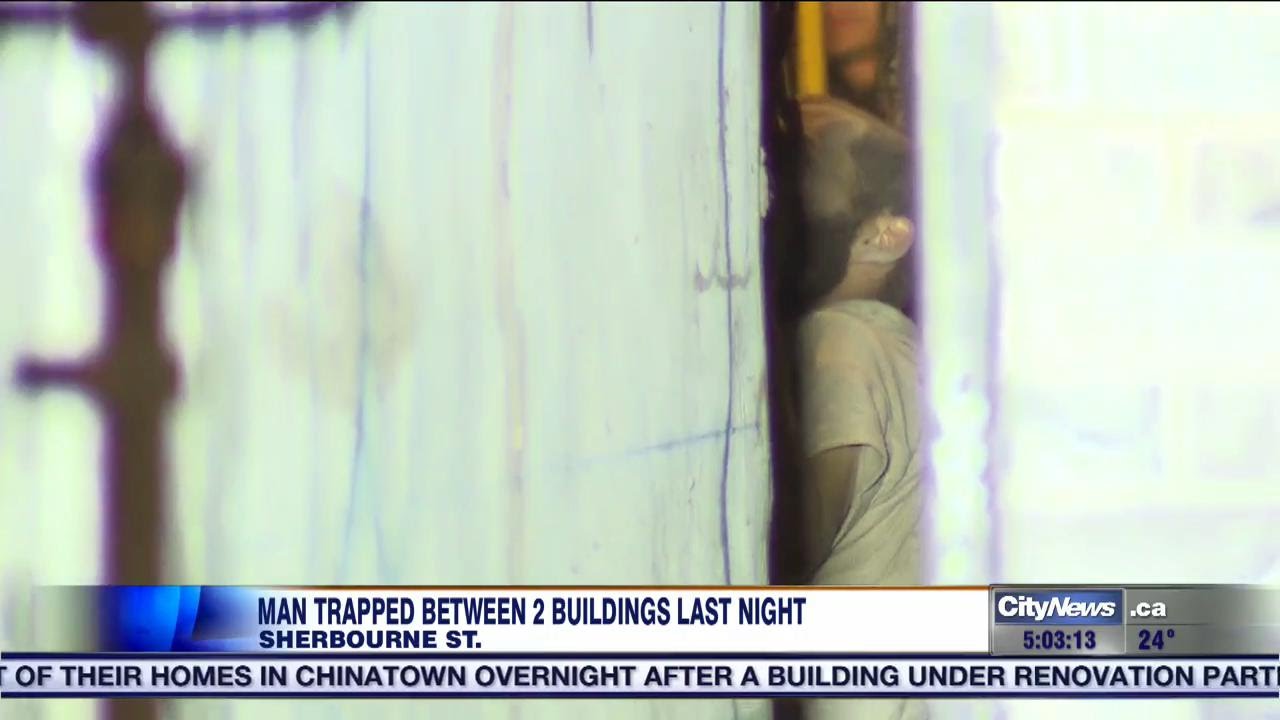 Man rescued after getting trapped between 2 buildings - YouTube