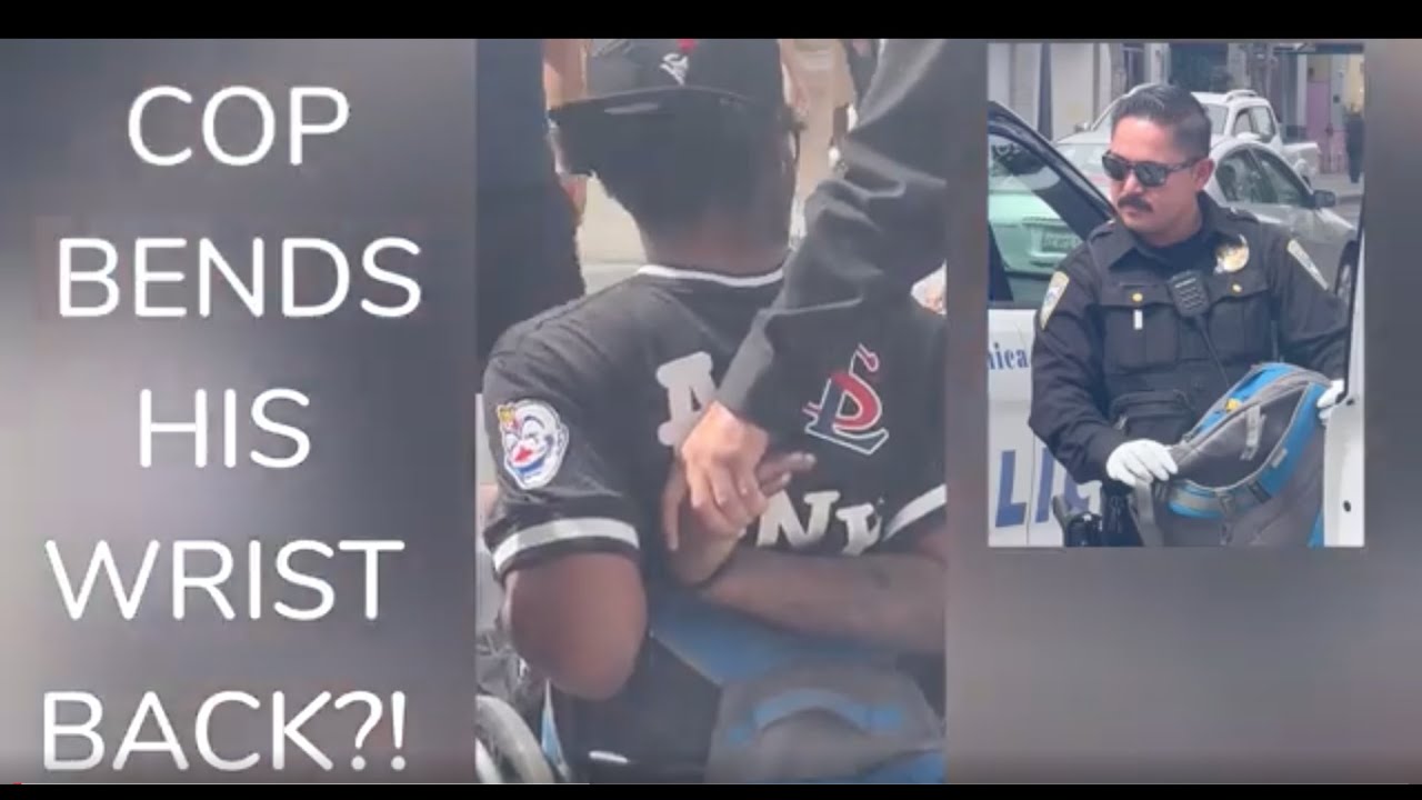 Cop bends man's wrist back who is handcuffed in a wheelchair ...