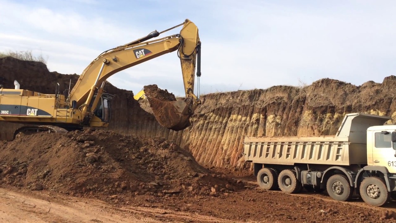 Caterpillar 365CL Excavator Loading Trucks - YouTube