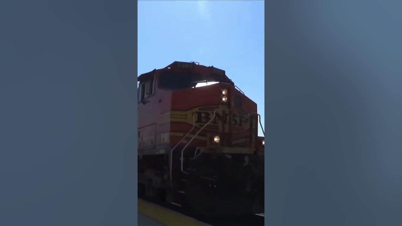 BNSF Dash 9 and a Gevo lead a westbound auto rack train through Fort Madison Iowa at track speed ...