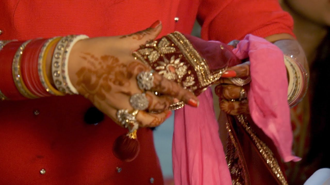 Performing gathbandhan wedding ritual which signifies together ...