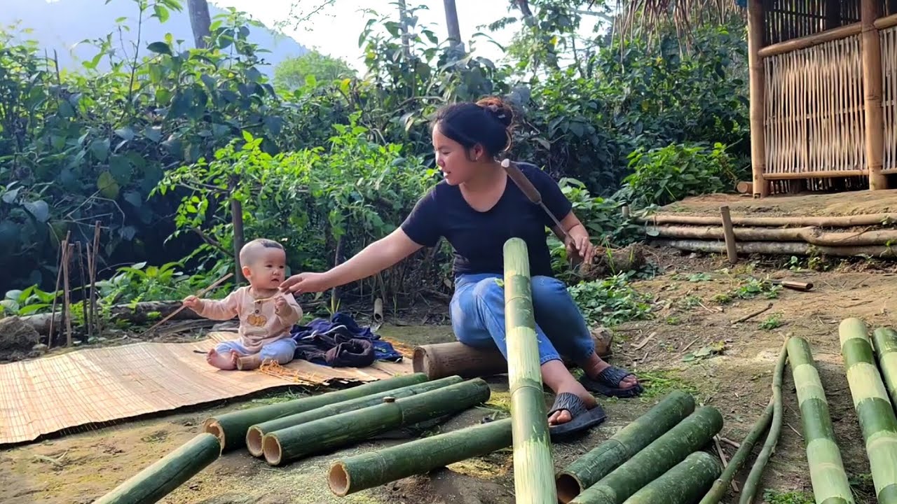Mother makes a bamboo cradle for baby to play in _ daily life in the ...