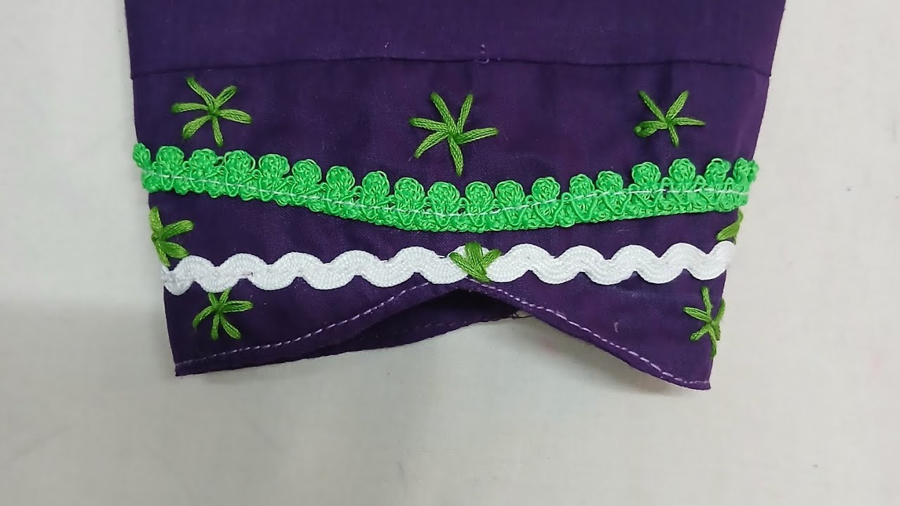 sleeve design with green floral embroidery and wavy lace detailing ...