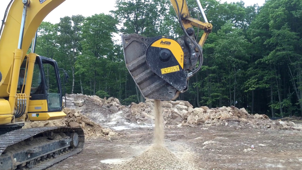 BF80.3 Crusher Bucket Crushing Bed Rock in the Rain - YouTube