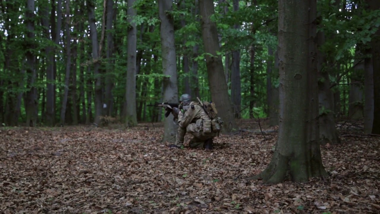 guerilla warriors squad running in one formation carrying their guns in ...