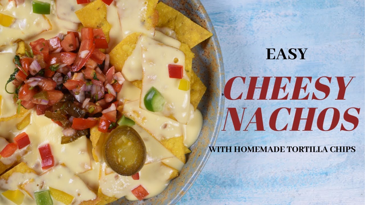 Nachos chips with cheese sauce - homemade corn tortilla chips , cheesy ...