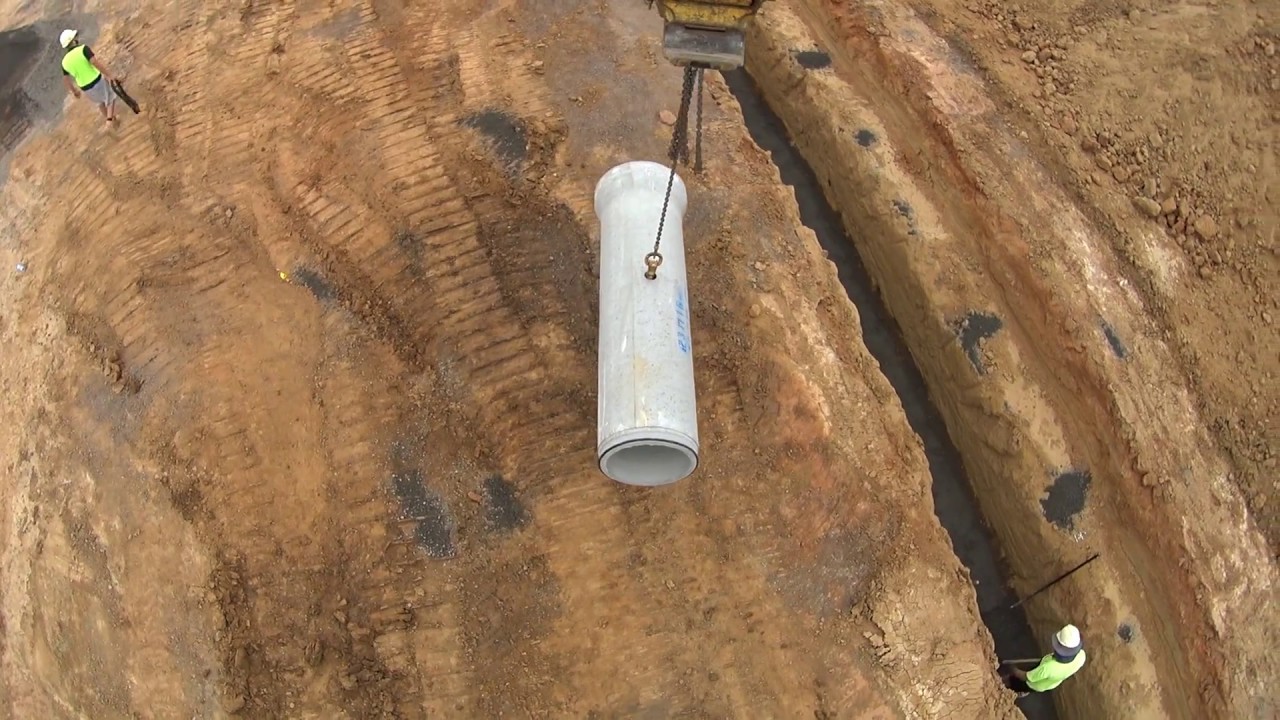 Overhead view laying 525mm/21 inch concrete stormwater line. - YouTube