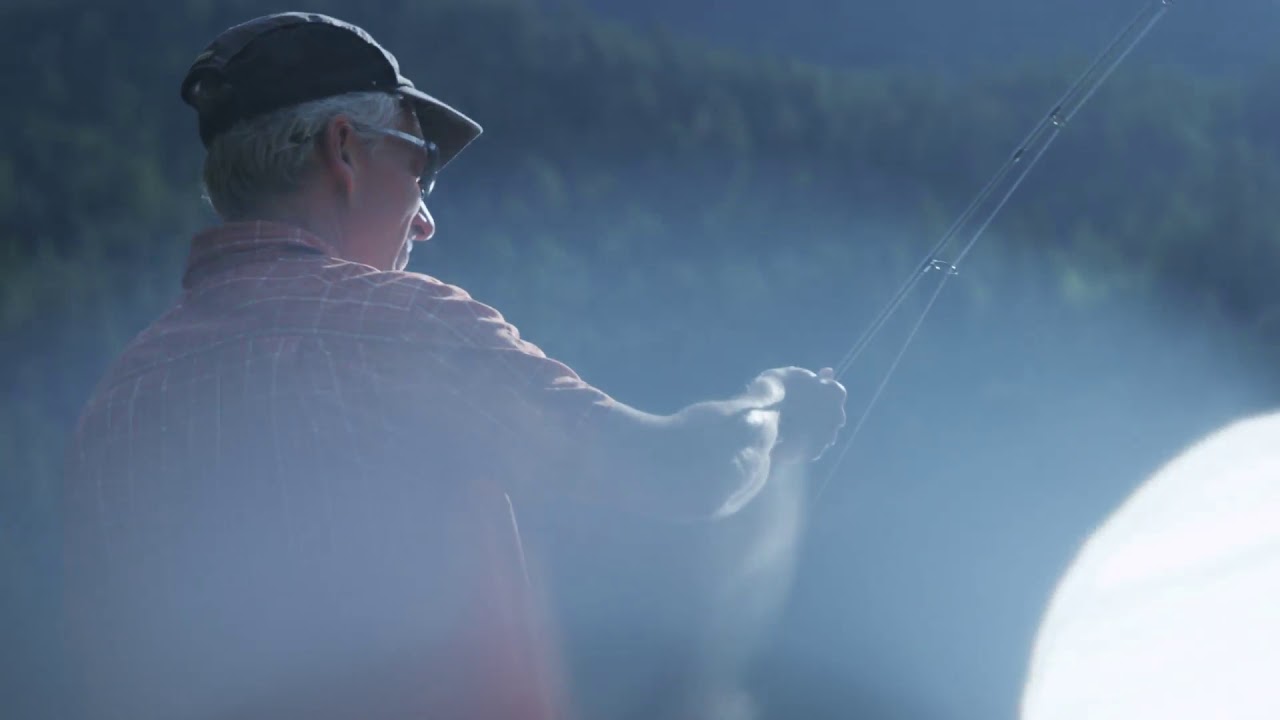 man reeling in fishing line while fishing - YouTube