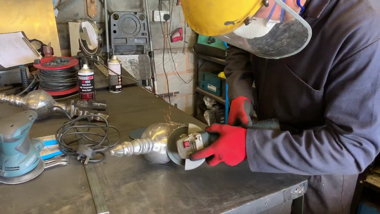 Linishing a hand cast dog iron - YouTube