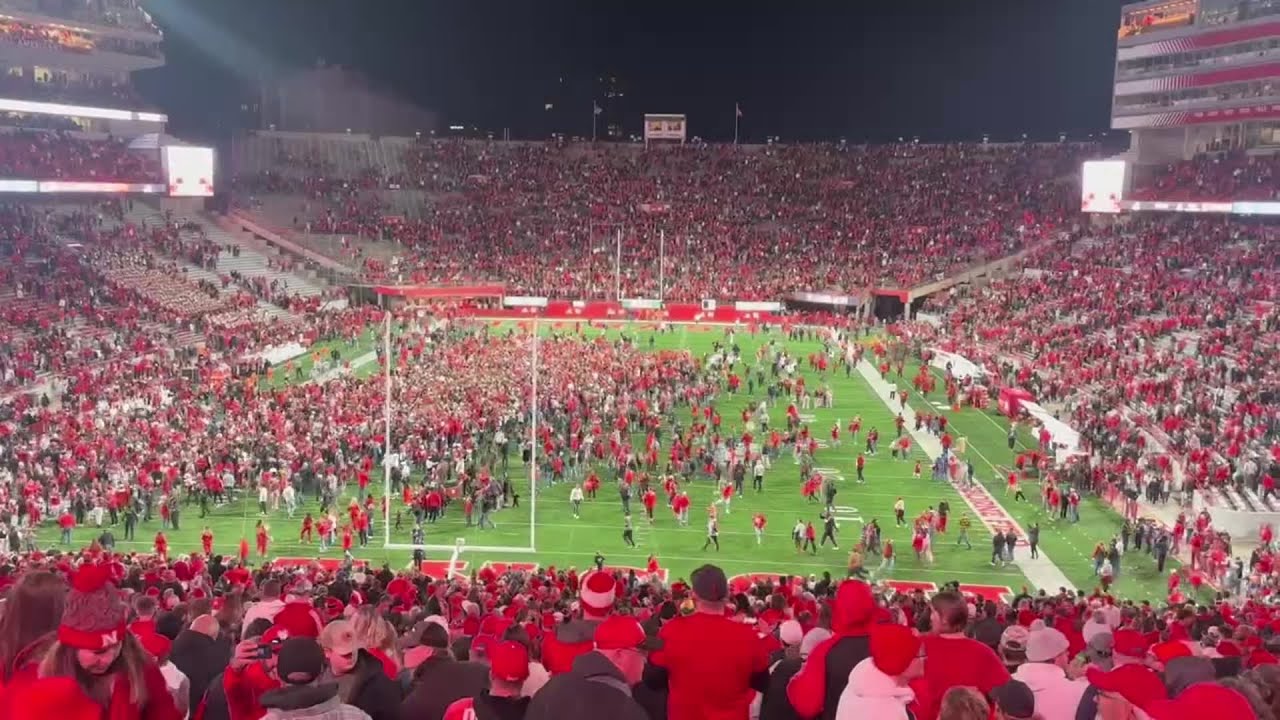 Nebraska fans rush field after 44-25 win over Wisconsin. - YouTube