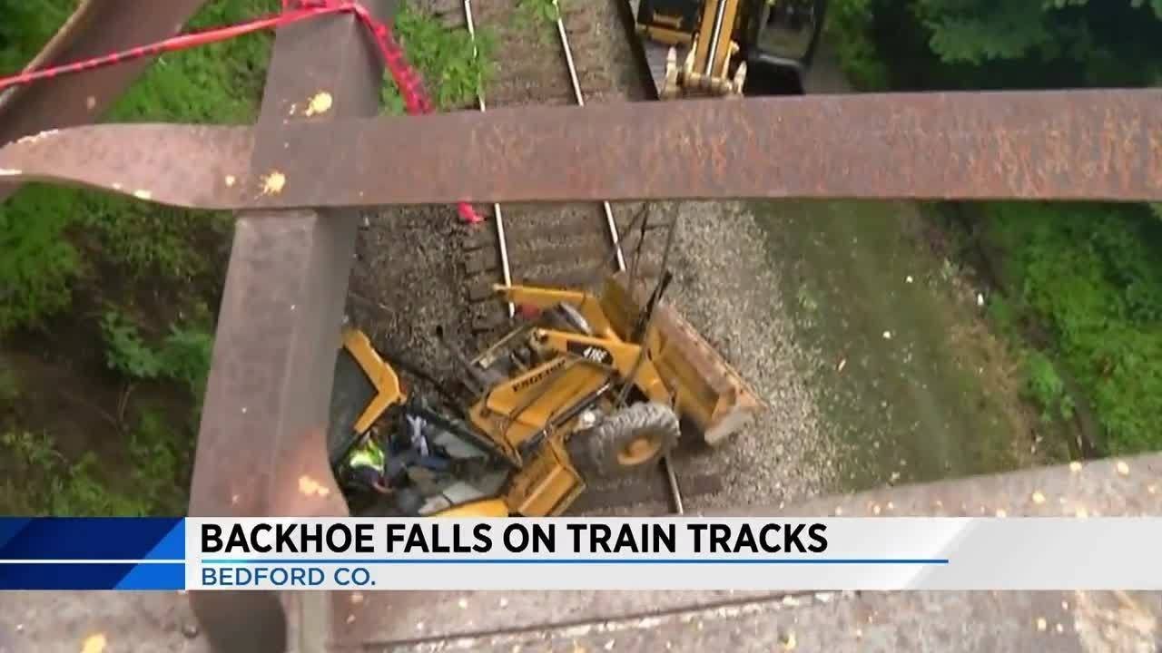 Crews respond after backhoe goes over bridge, hit by Amtrak train in ...