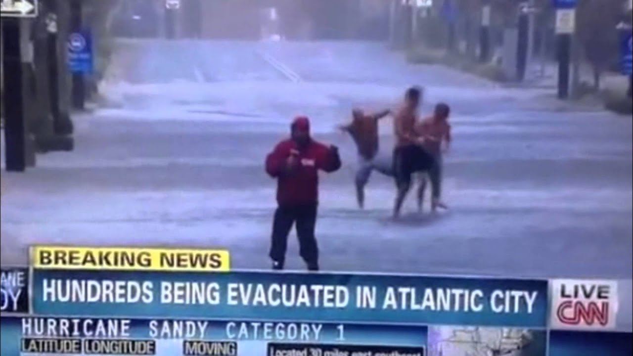 people dancing behind CNN reporters (hurricane Sandy) - YouTube