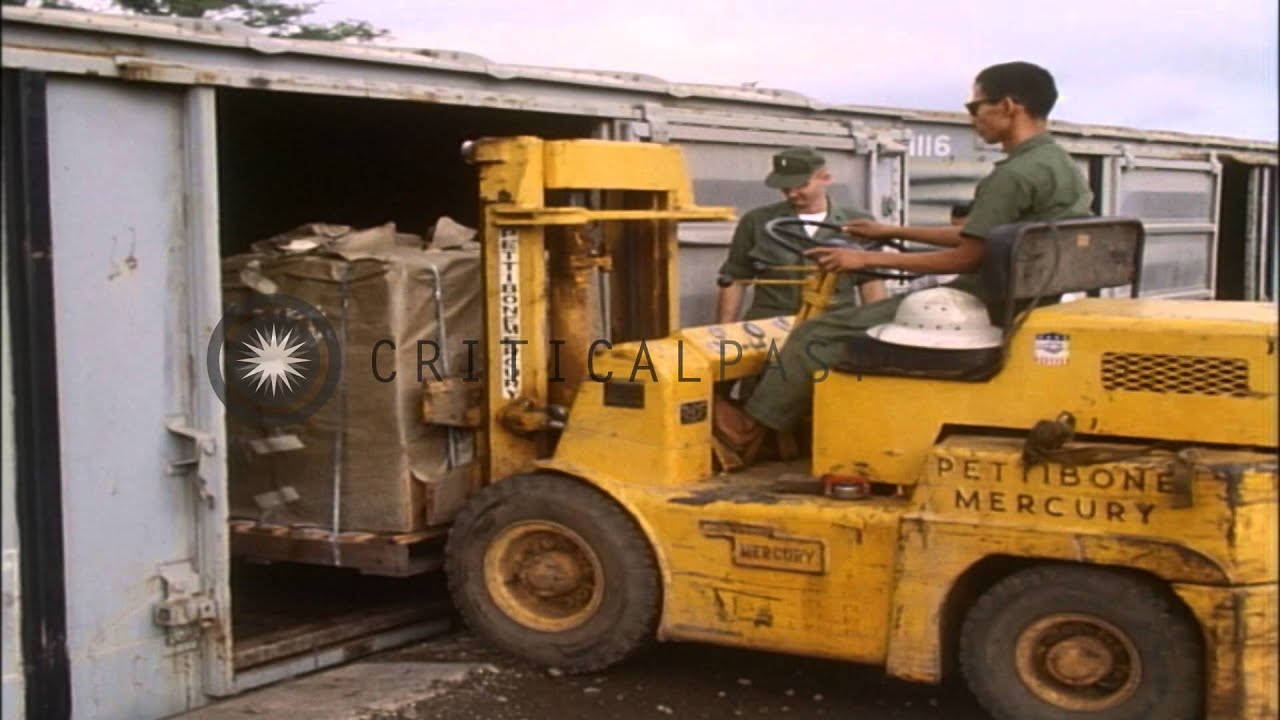 Forklift loads supplies into boxcar at a railroad yard in Saigon ...