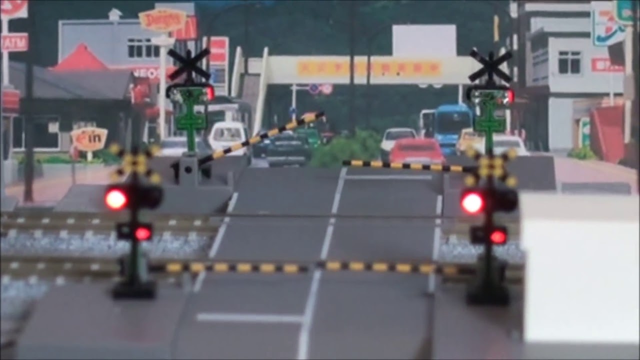N scale train passes through the railway crossing. - YouTube