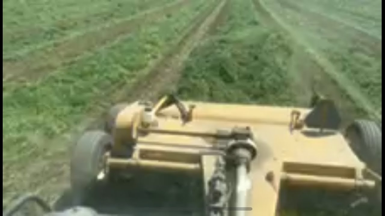 Hay conditioning and raking hay - YouTube