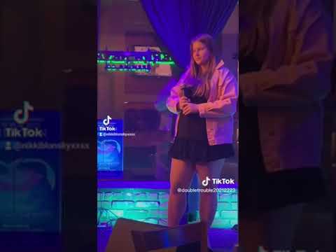 Julia singing in a karaoke bar enjoying herself