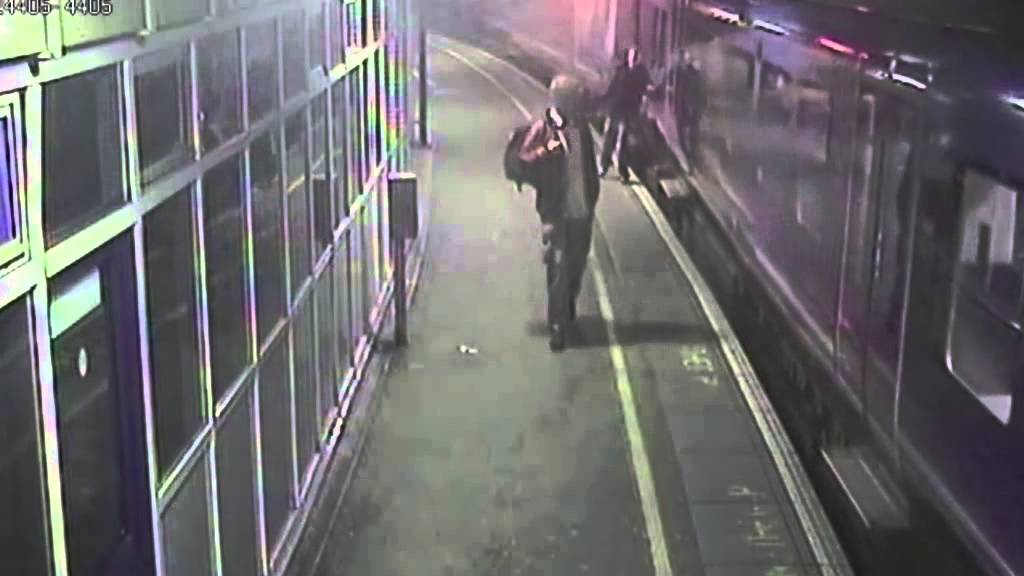 Man falls head first underneath MOVING train and survives - YouTube