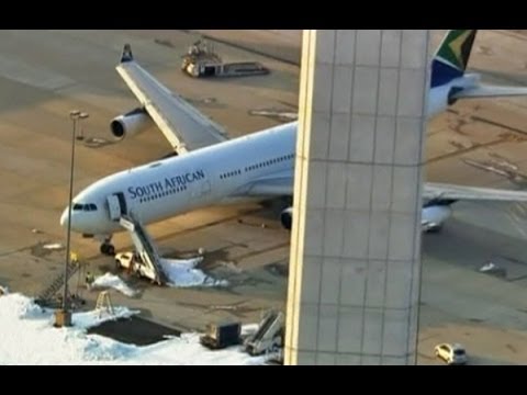 Man's body found in wheel well of SAA plane - YouTube