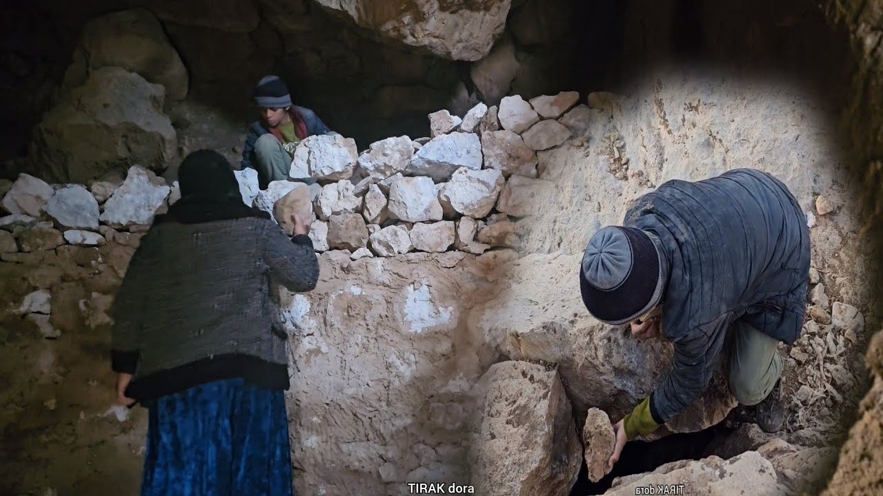 Falling stone from the roof of the cave and building a stone wall ...