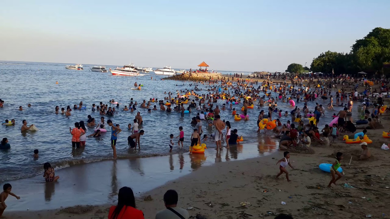 Beach full of people. Colorful, sunny evening. Thousands of mc parked ...