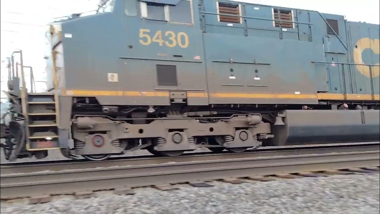 12/18/22CSX M426approaches Cross Rd crossing in Bradford Mass. Gets passed by a Keolis ...