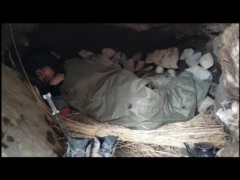 Building a warm and cozy stone shelter with a chimney fireplace. Winter ...