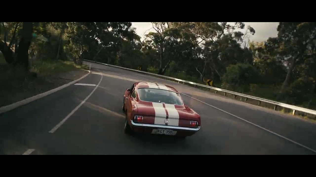 Red Car Riding Around Bend In Road At Sunset Stock Video Footage Stock ...