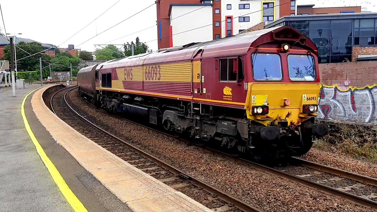 Class 66 hauls a coal train past Manors consisting of wagons with ...
