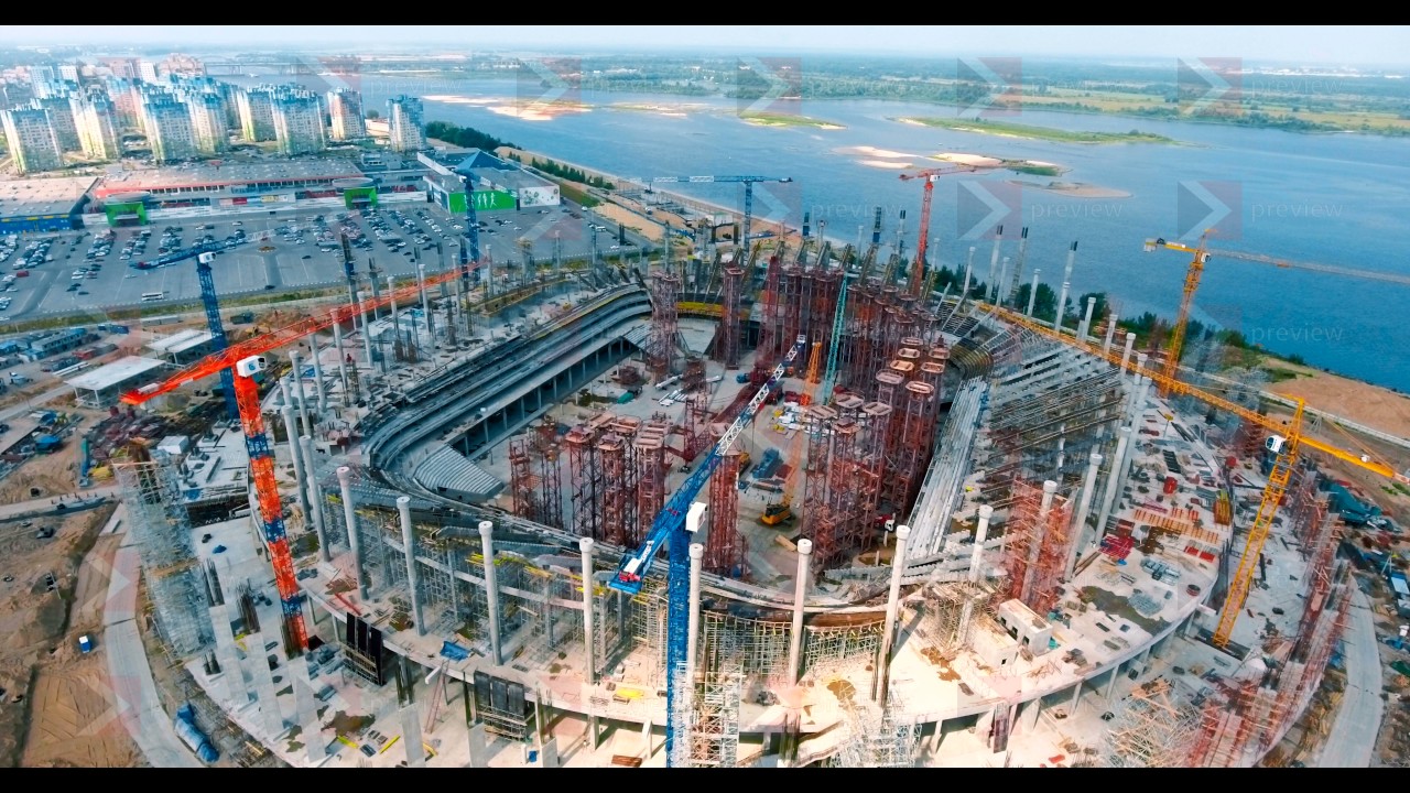 Aerial. Building of a stadium near a city and a river. - YouTube