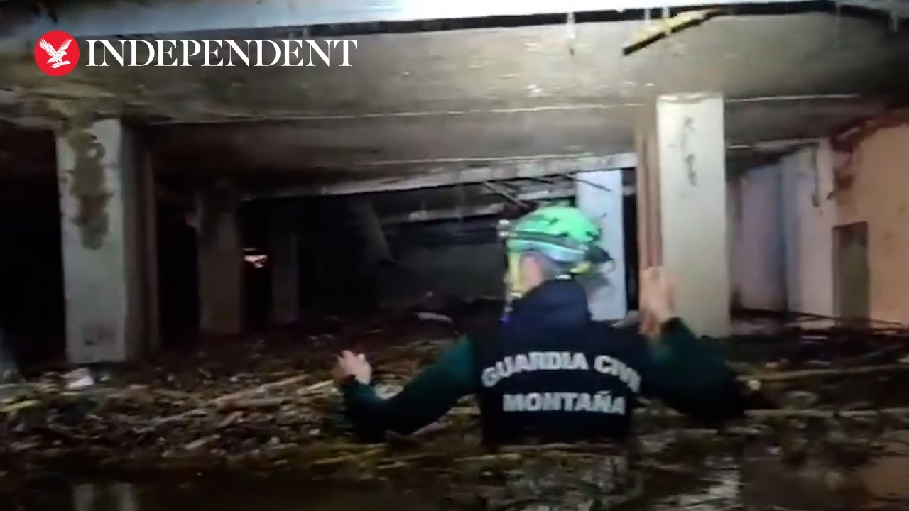 Spain floods: Rescuers wade through chest-high water as death toll ...