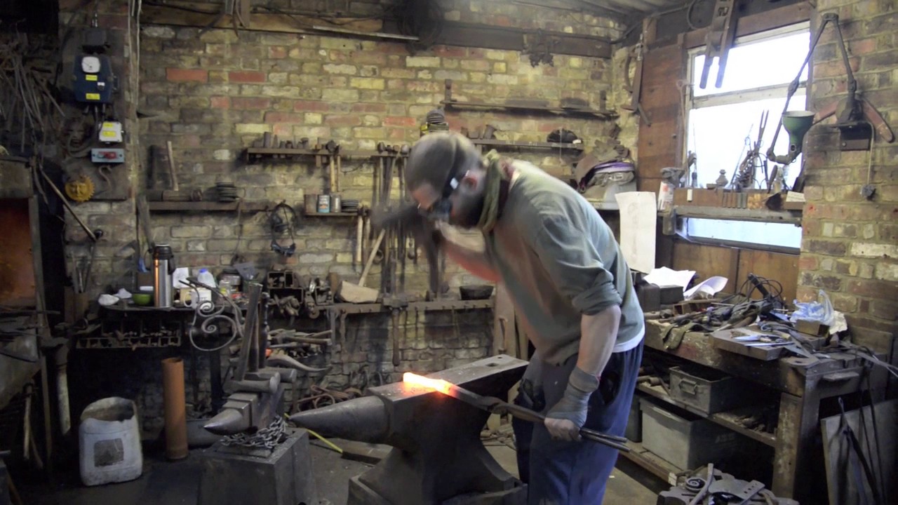 Petefire blacksmith forging 25mm square stock into 18mm square stock in ...