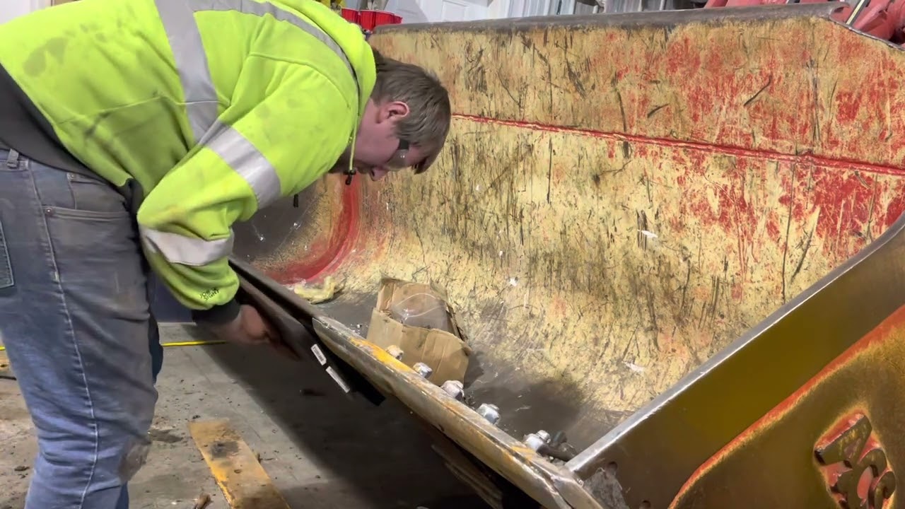 New cutting edges installed on front end loader - YouTube