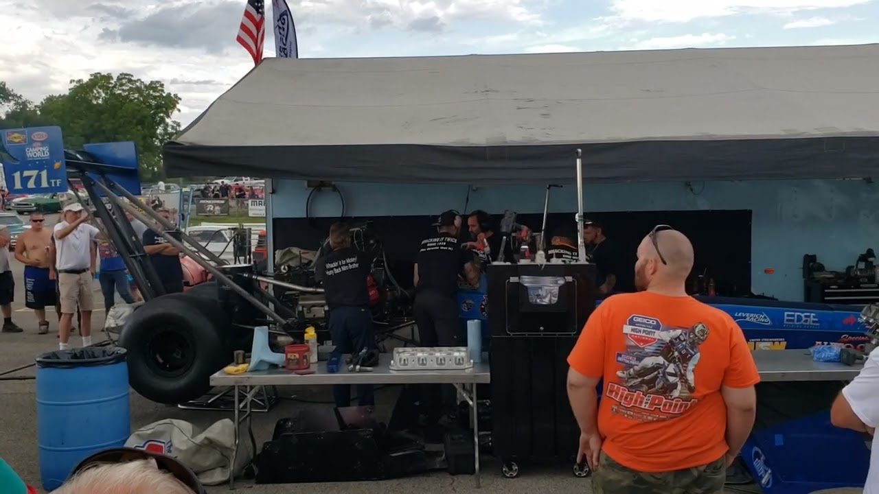 The Leverich racing team starting up the Nitro car in the pits at night ...