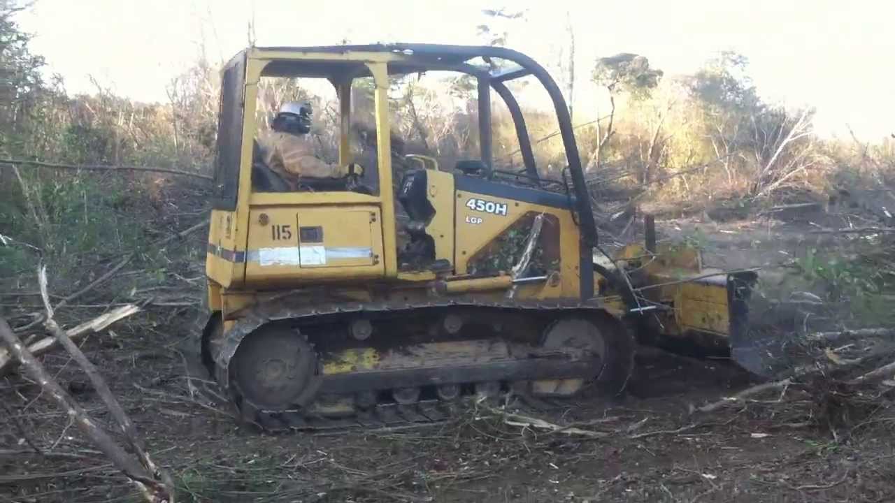 David clearing land using JD 450H Dozer - YouTube