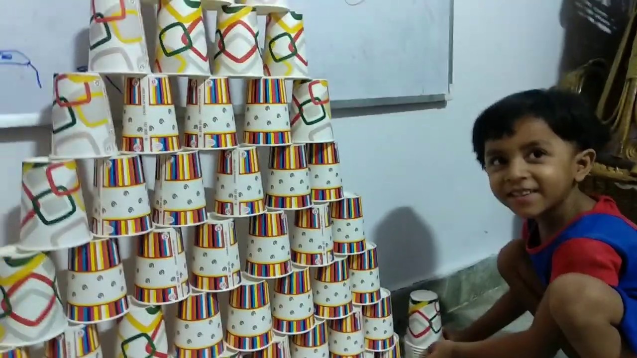 Tower Pyramid of glasses by kid. Home play activity for children. Fun ...